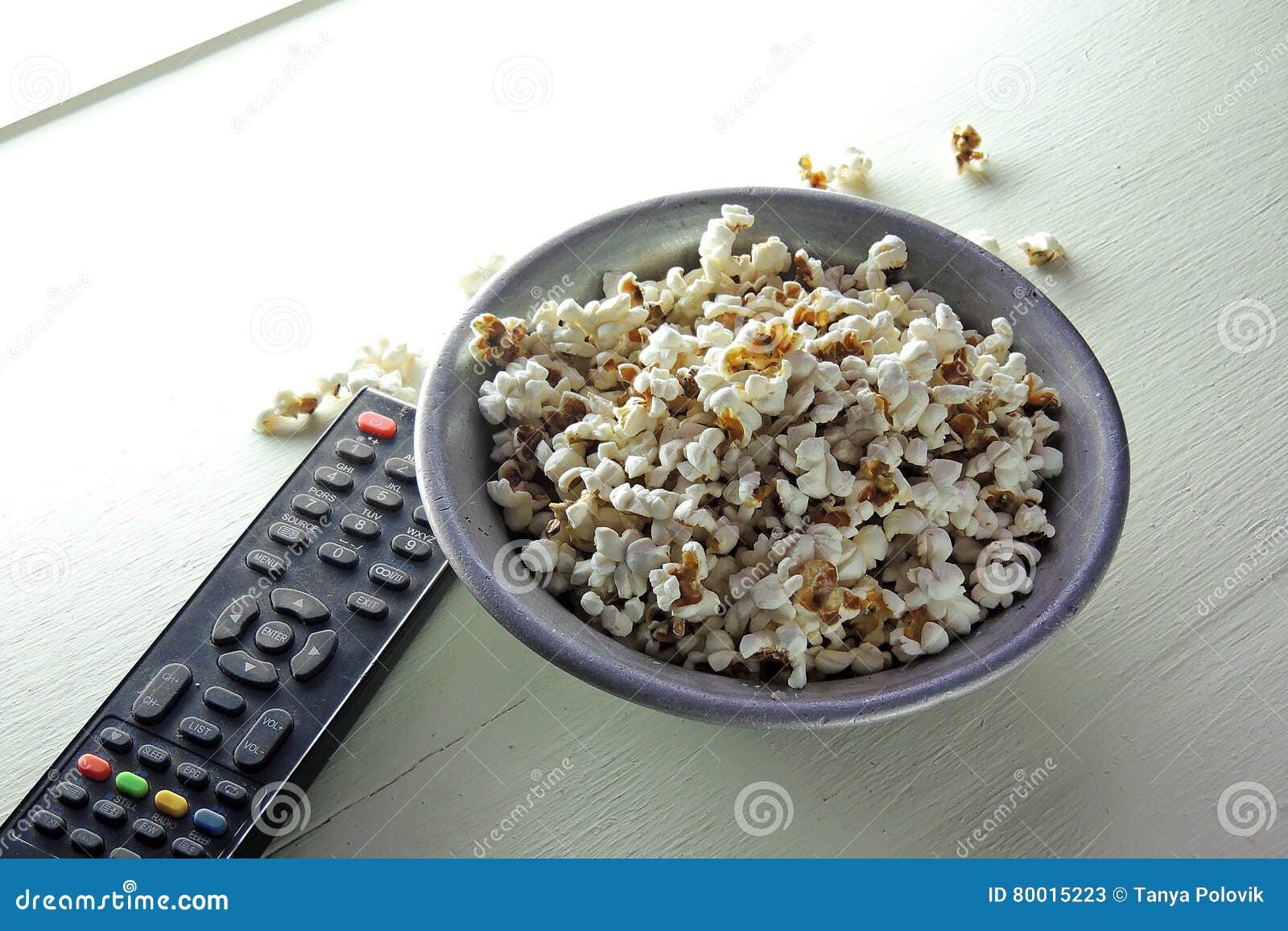 Popcorn and the TV remote stock image. Image of bowl - 80015223
