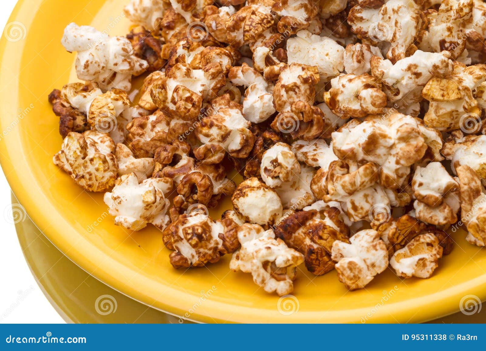 Popcorn on a yellow plate stock photo. Image of effect - 95311338