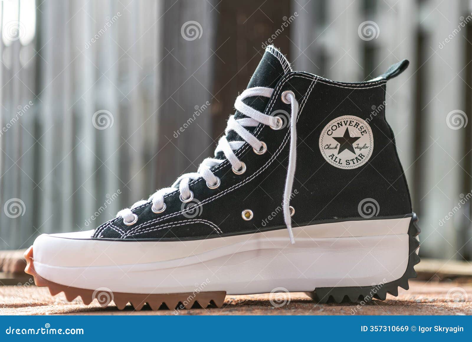 Popular Canvas Black Converse Sneakers on a Paved Sidewalk. Side View ...