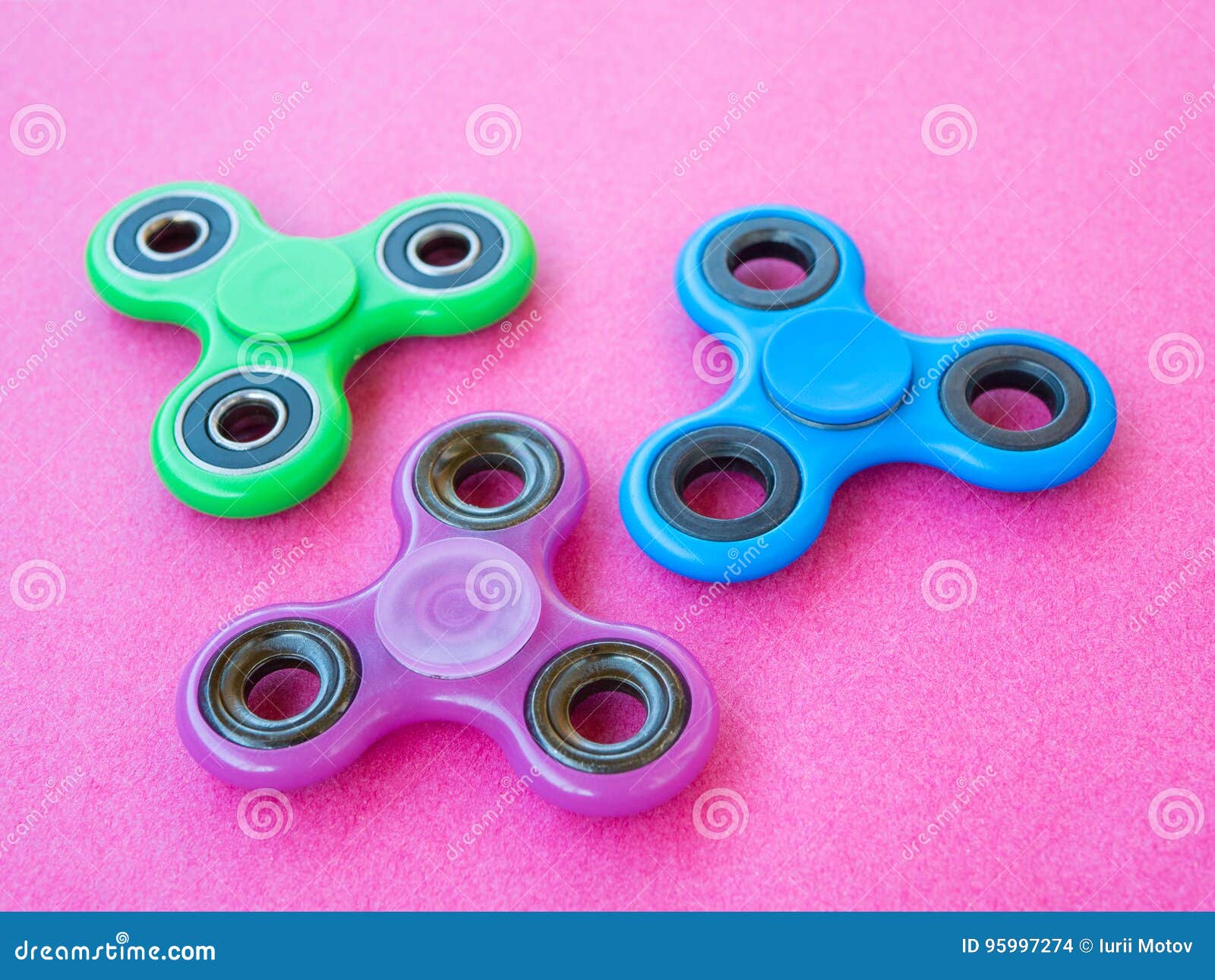 Popular Colourful Fidget Spinner Toy on a Colored Background Stock ...