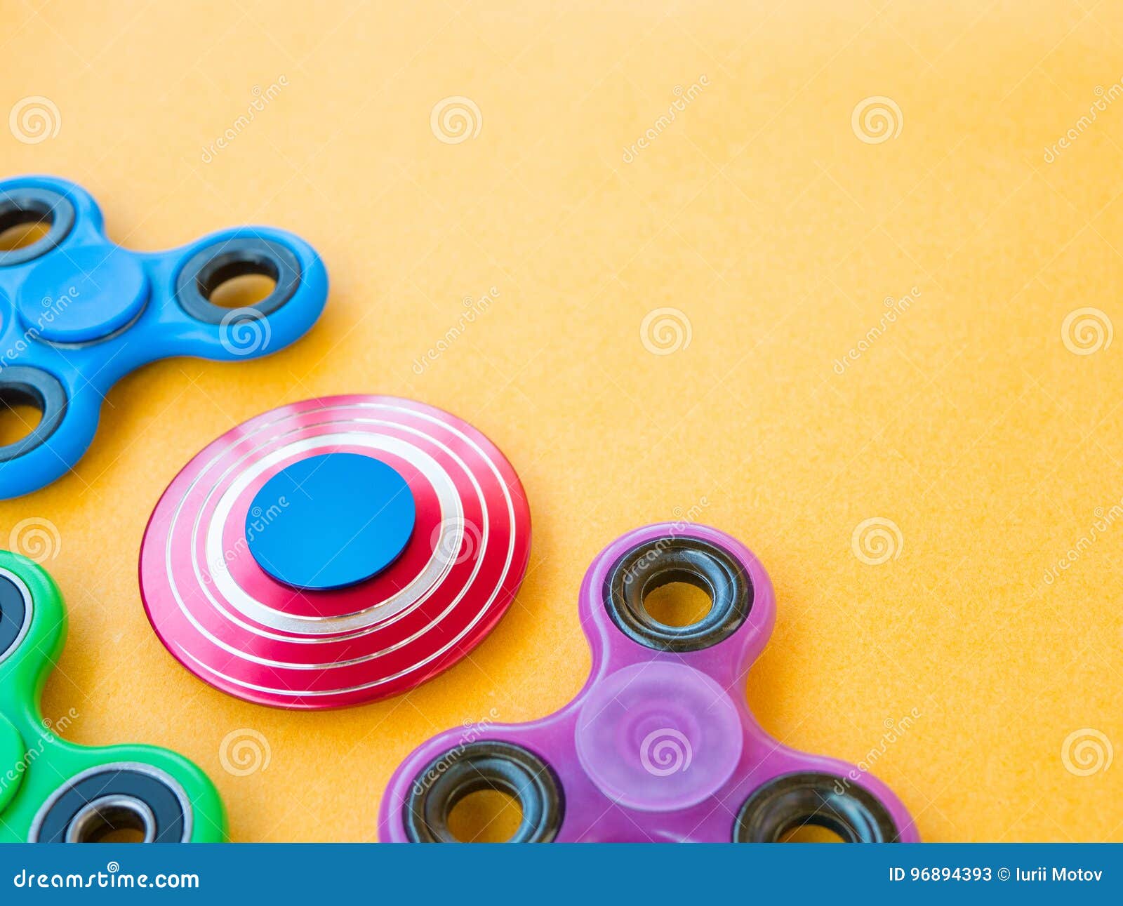 Popular Colourful Fidget Spinner Toy on a Colored Background Stock ...