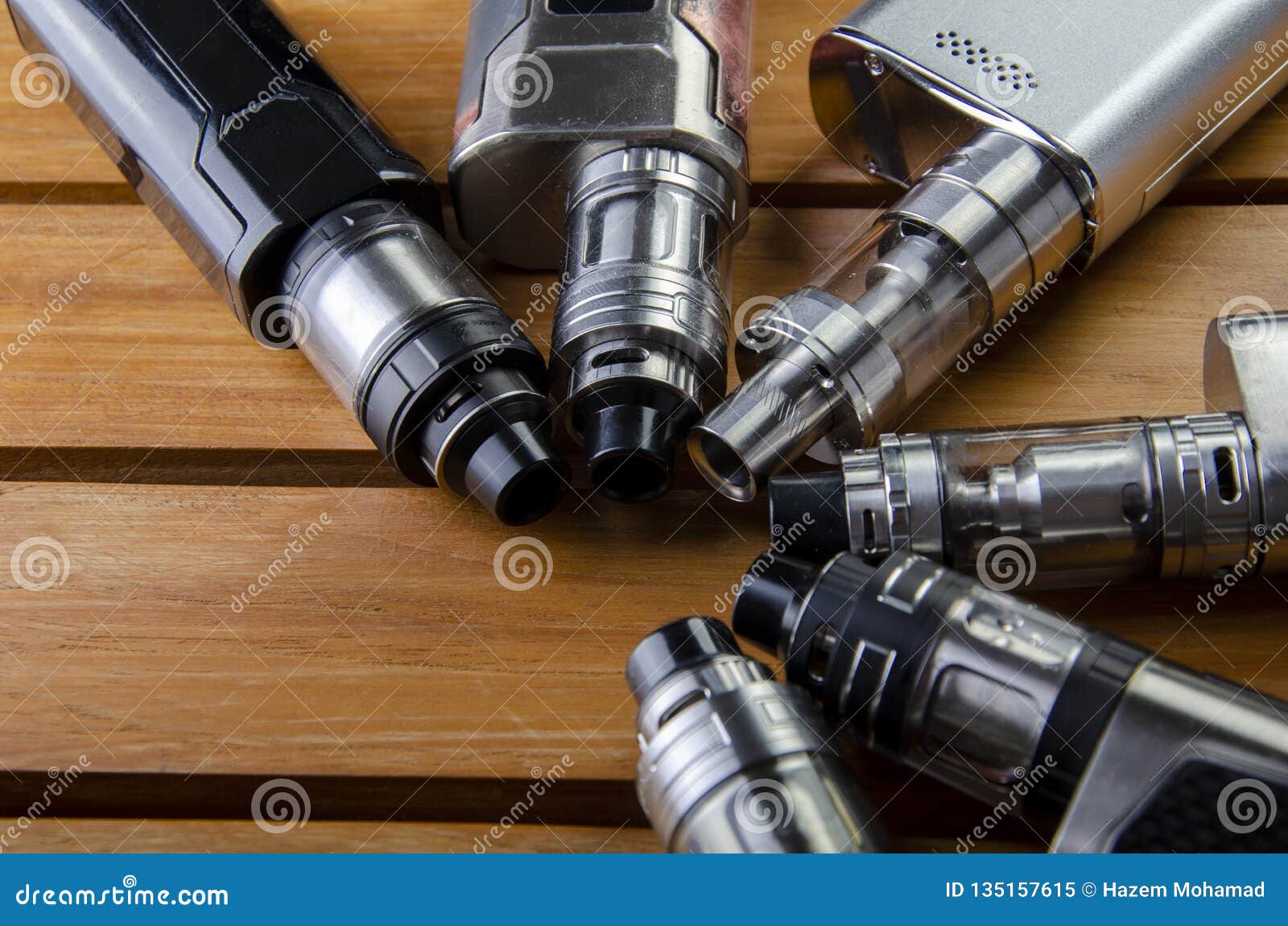 Electronic Cigarette Mods for Ecig Over a Wooden Background. Vape ...