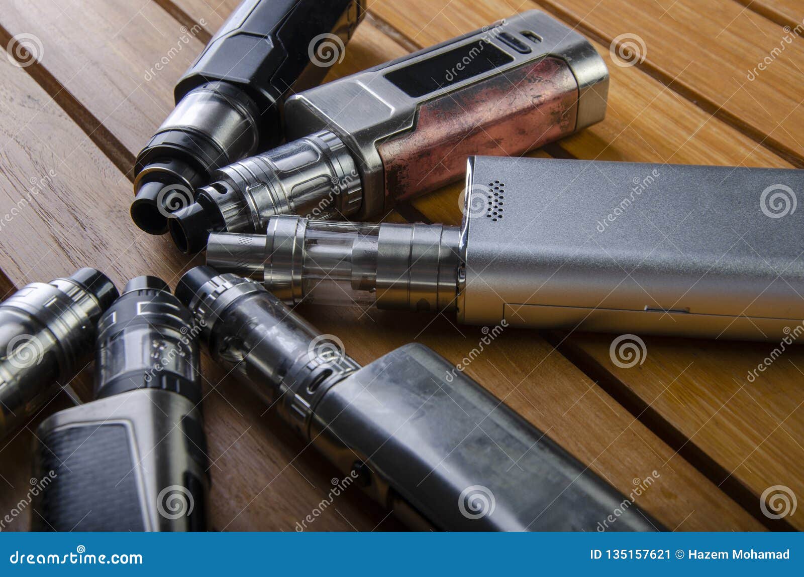 Electronic Cigarette Mods for Ecig Over a Wooden Background. Vape ...