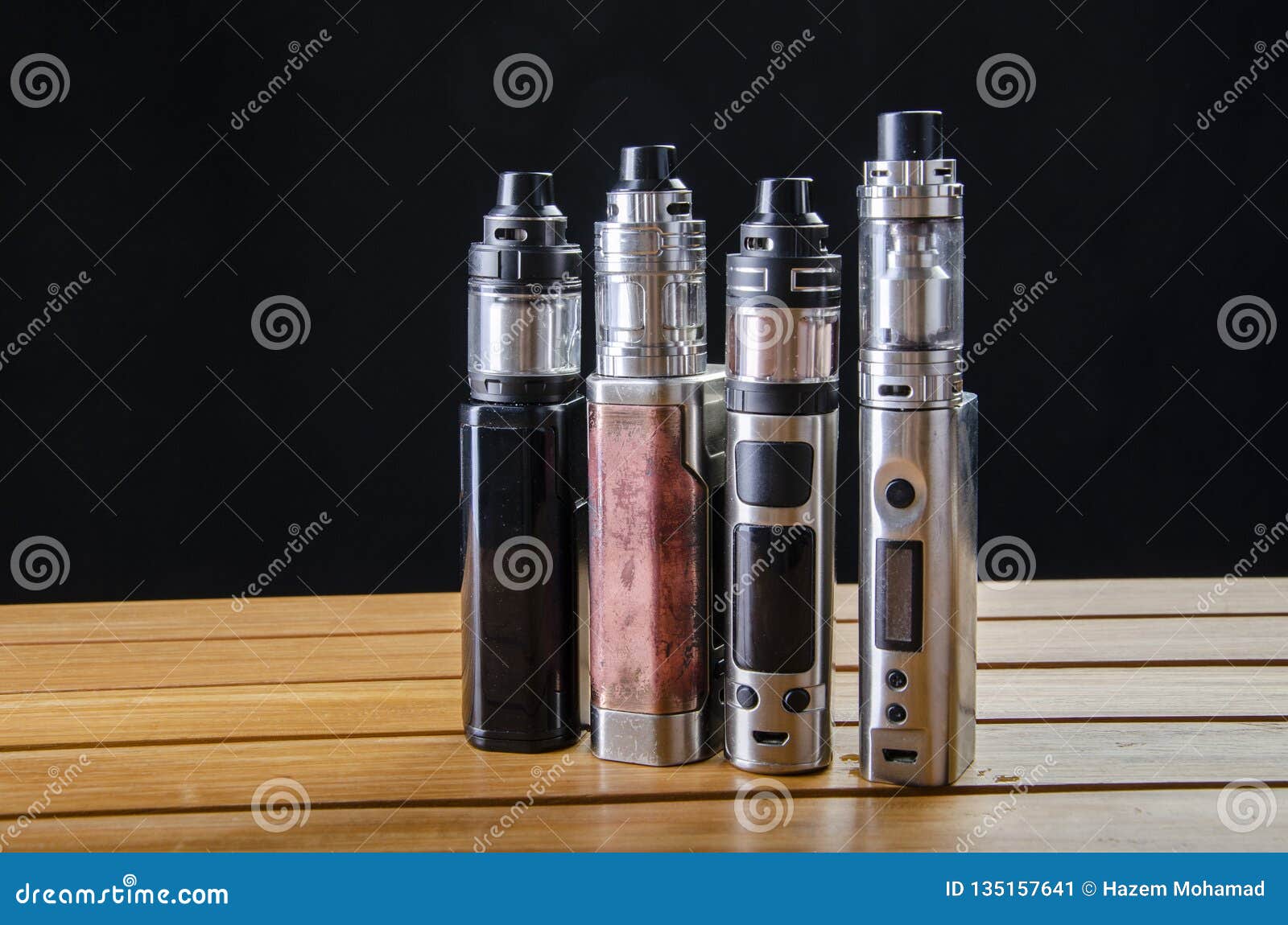 Electronic Cigarette Mods for Ecig Over a Wooden Background. Vape ...