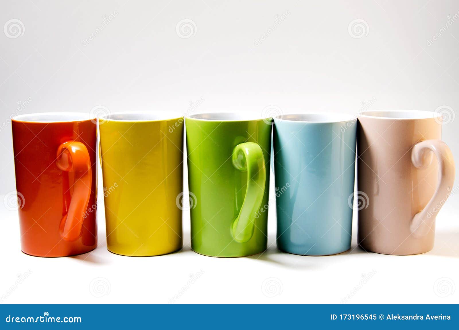 Porcelain Cups Of Different Colors Stand On A White Background. Isolate ...
