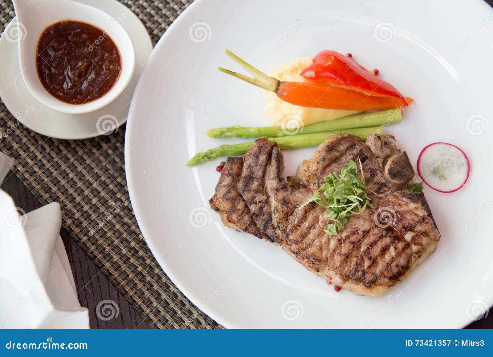 Pork chop on a white plate stock image. Image of cooked - 73421357