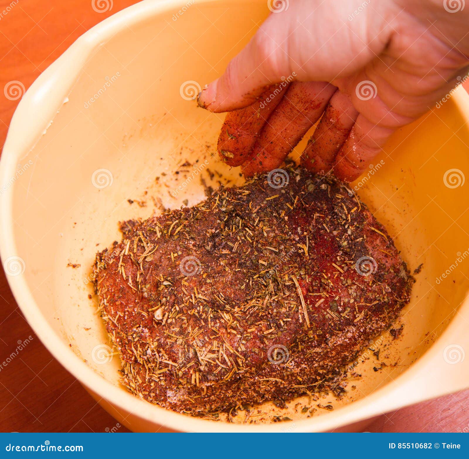 Pork loin being seasoned stock photo. Image of plate - 85510682