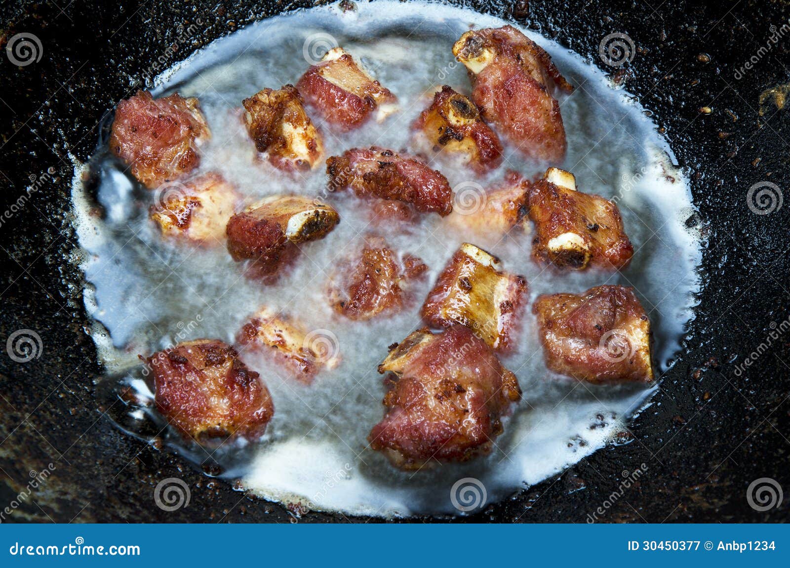 Pork in oil pan. stock image. Image of meal, bones, golden - 30450377