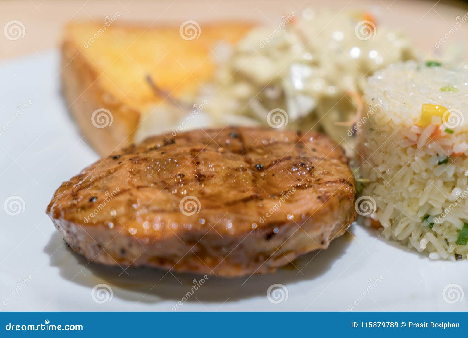 Pork Steak with Salad and Rice on White Dish in Restaurant. Stock Image ...