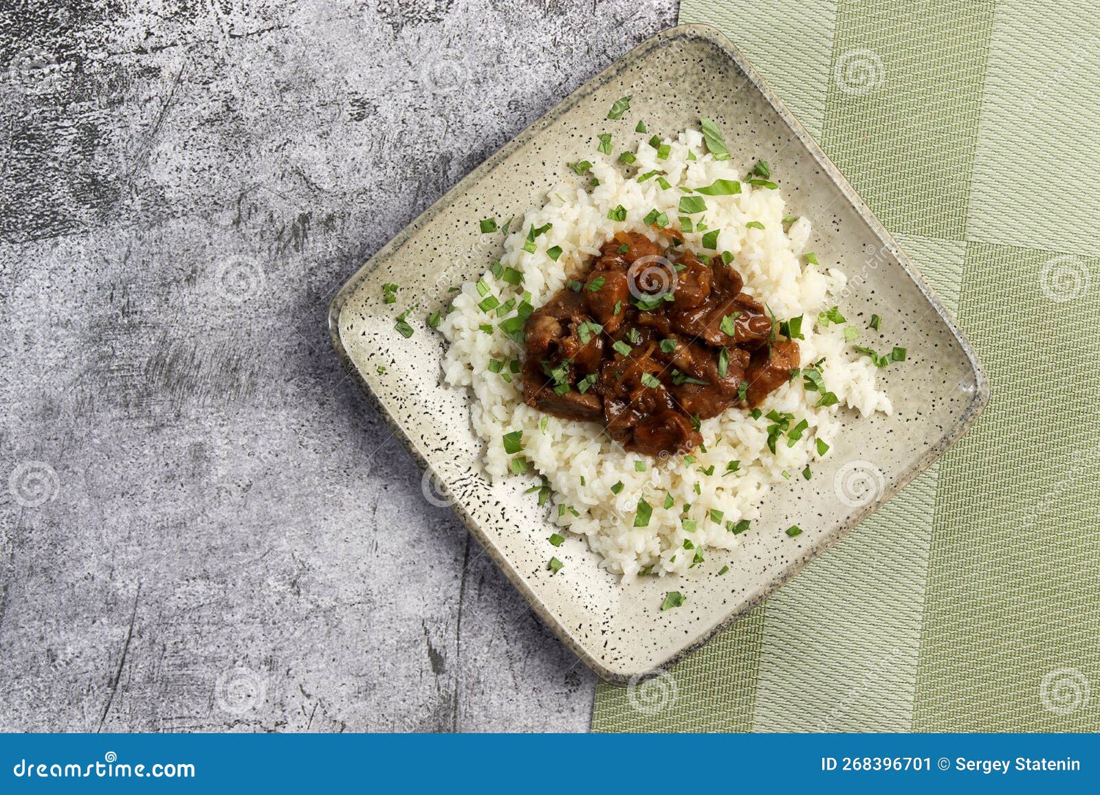 Pork Stew with Rice and Herbs on a Square Plate on a Dark Background ...