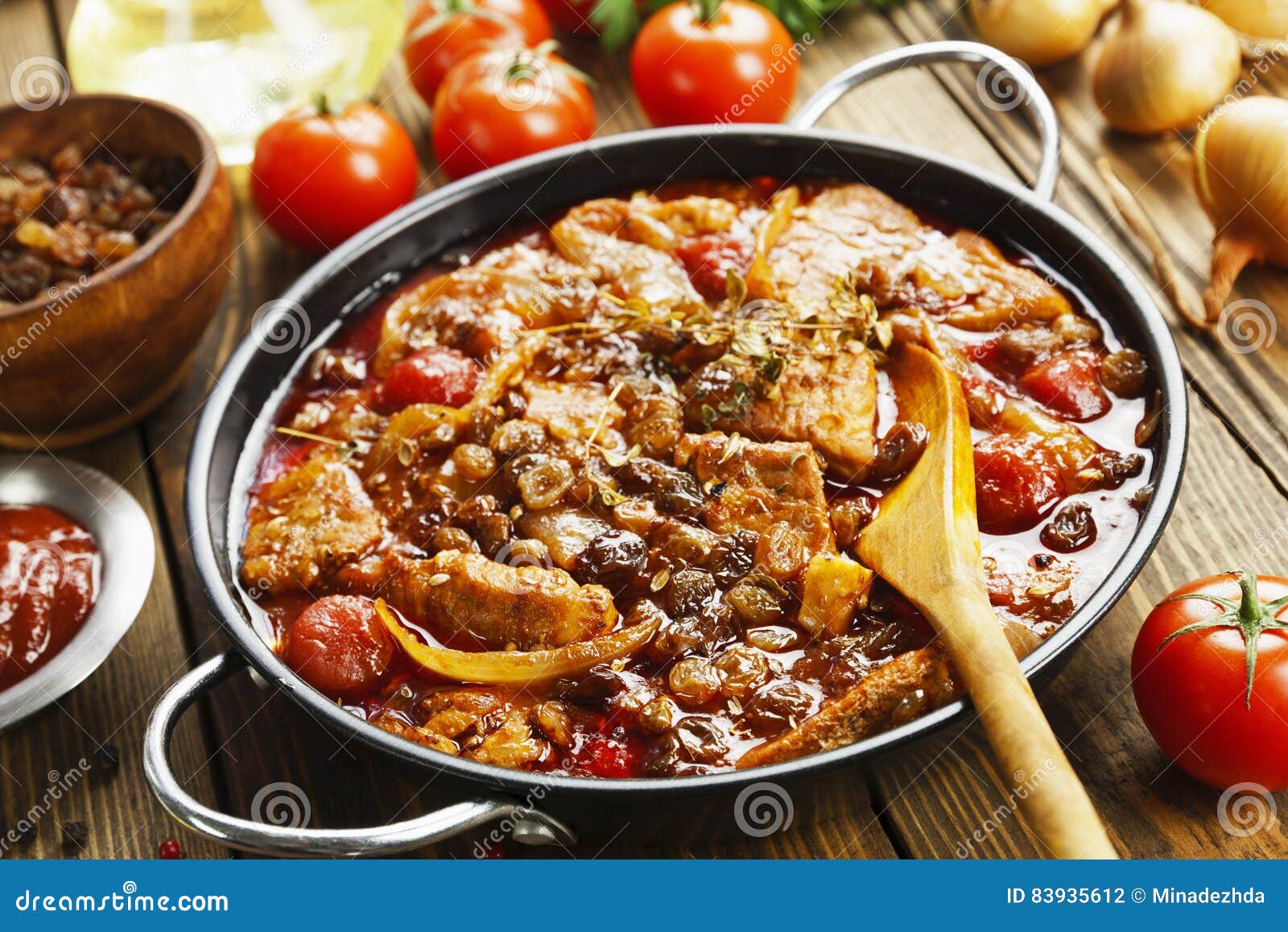 Pork Stew with Tomatoes and Raisins Stock Photo - Image of wooden ...