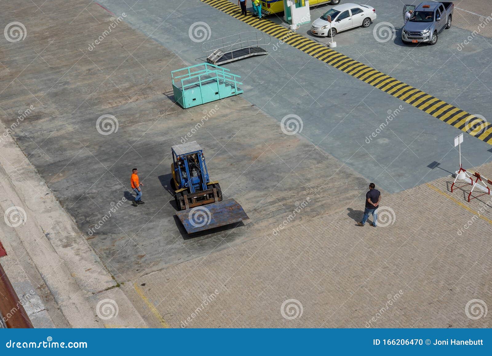 Port Dock Workers Using a Forklift To Setup a Ramp To Transport ...