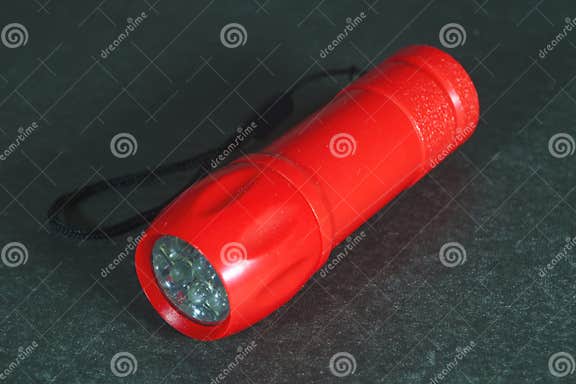 Portable LED Flashlight Red Color Isolate on a Grey Background. Close ...