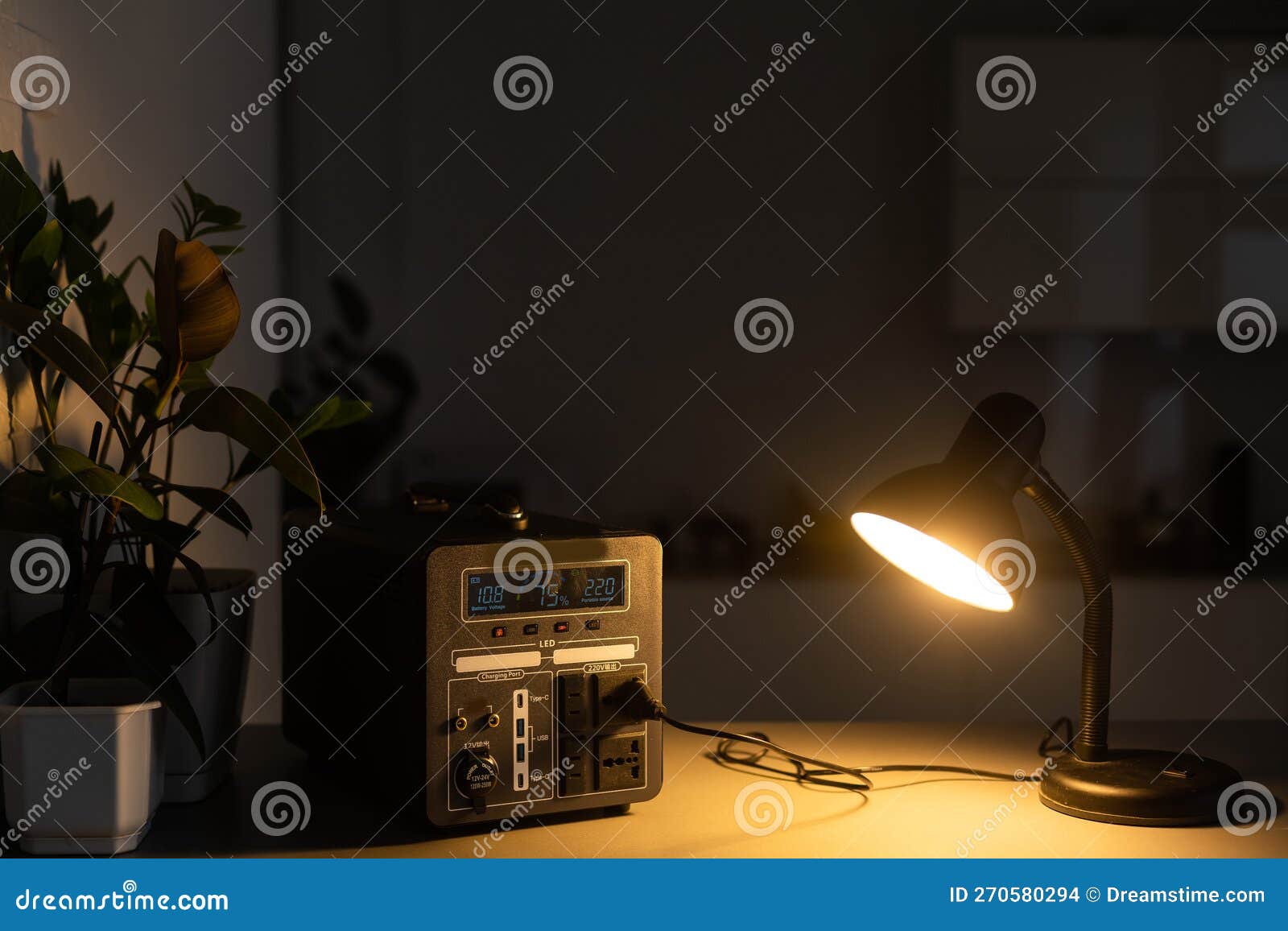 Portable Power Station Charging Gadgets on Table in Room. Stock Photo ...