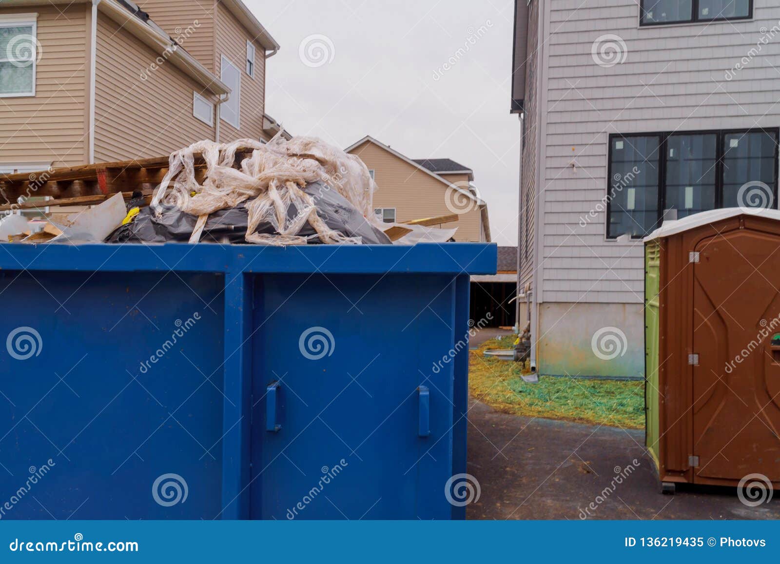 Portable Restroom on a Dumpsters Being Full with Garbage New House ...