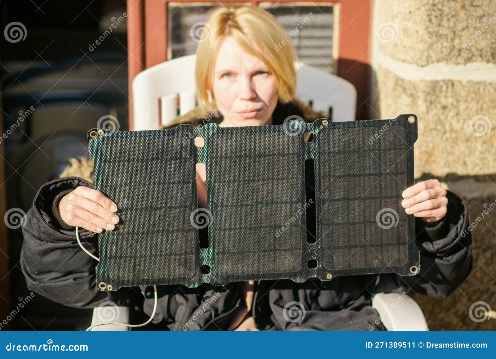 Portable Solar Battery in the Hands of a Woman. Alternative Energy ...