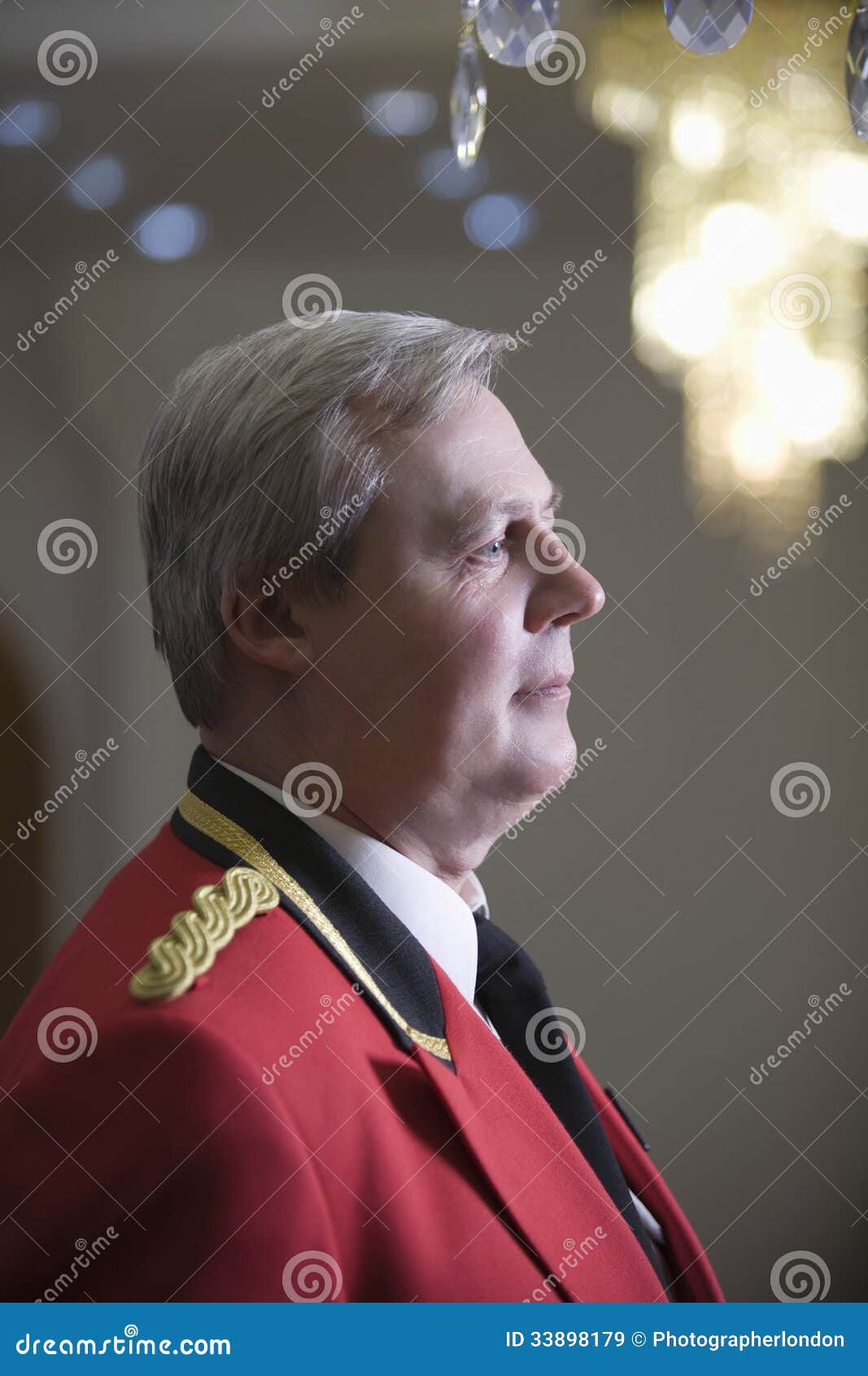 Porter in Red Jacket Looking Away Stock Image - Image of middle ...