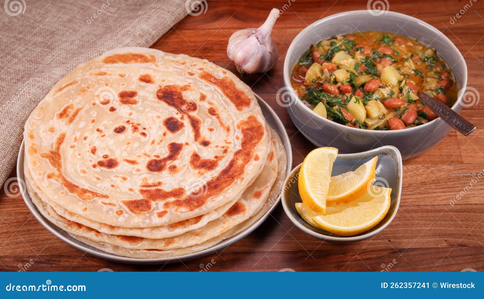 Portion of African Chapati, Bean Stew, Garlic, and Lemons Stock Image ...