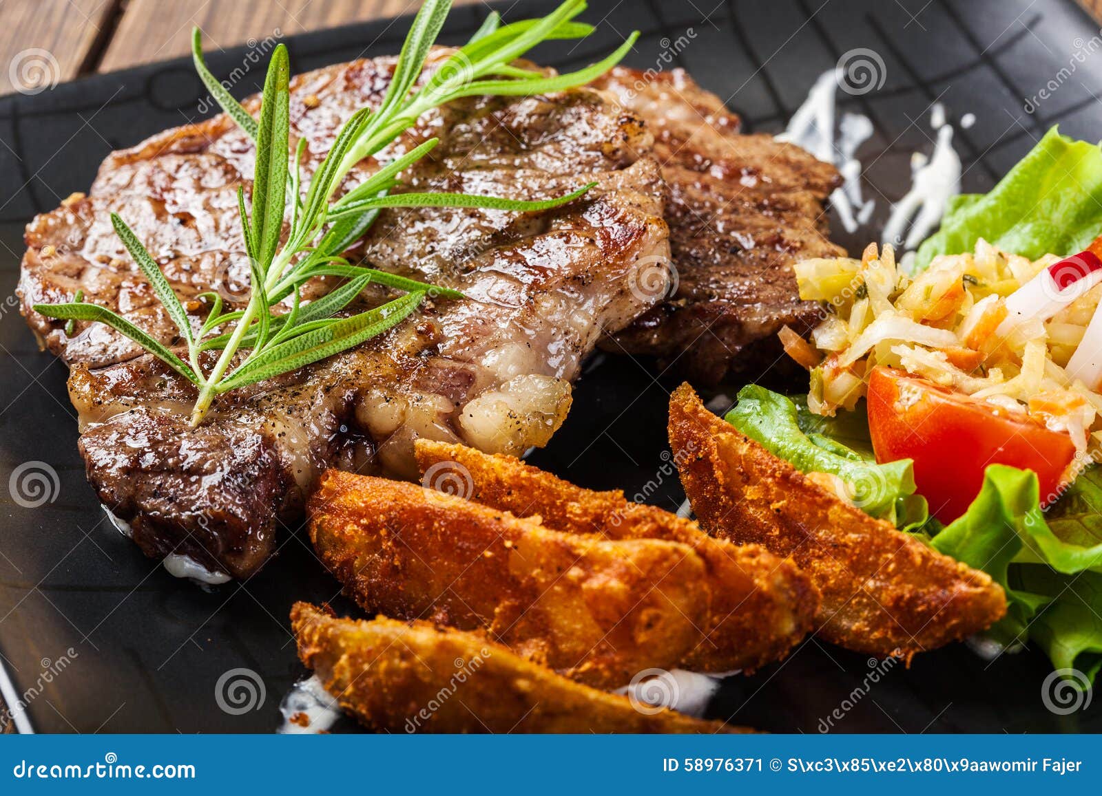 Portion of Beef Steak Served with Roast Potatoes Stock Image - Image of ...