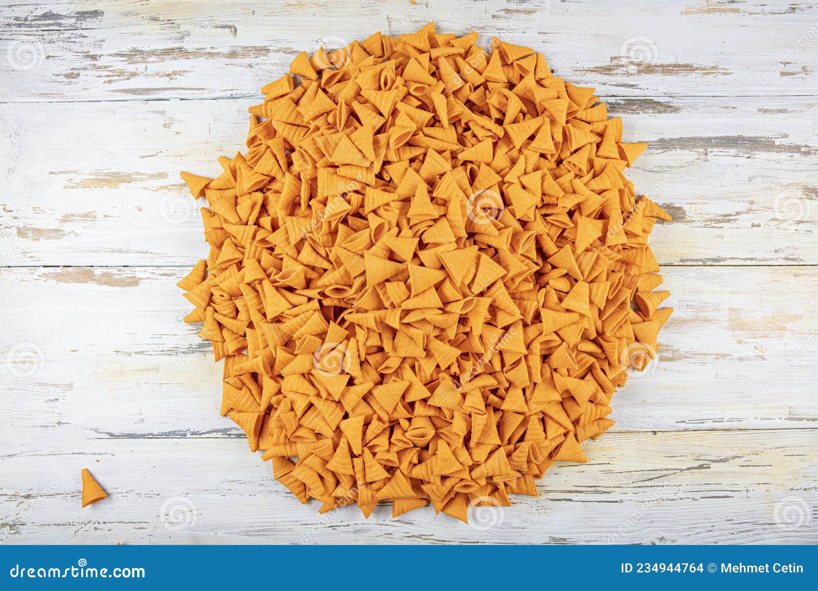 Portion of Cone Shaped Snack Tornado Shaped Crackers. Yellow Spicy ...