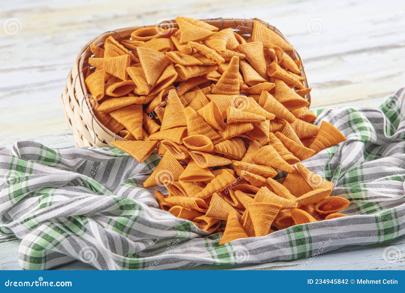 Portion of Cone Shaped Snack Tornado Shaped Crackers. Yellow Spicy ...