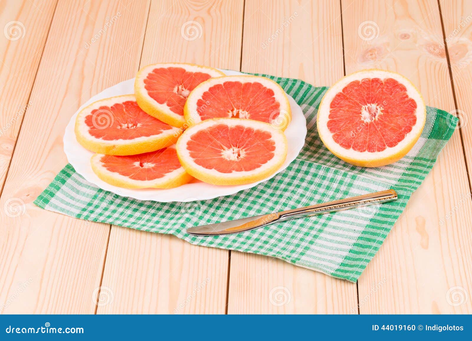 Portion of Sliced Grapefruit on Plate. Stock Photo - Image of knife ...