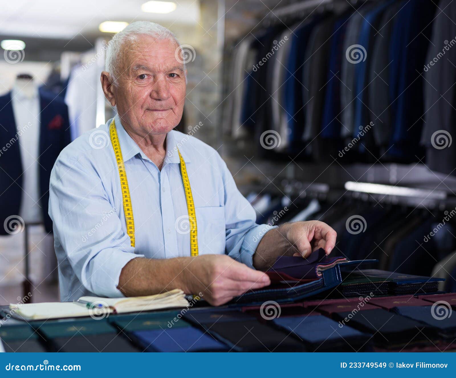 Portrait of an Accomplished Tailor with Samples of Fabric in Atelier ...