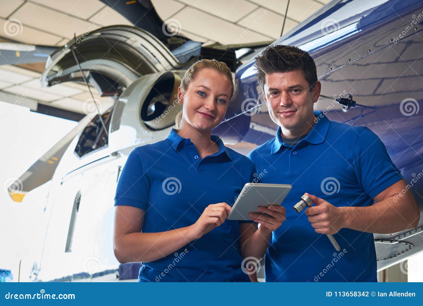 Portrait of Aero Engineer and Apprentice Working on Helicopter I Stock ...