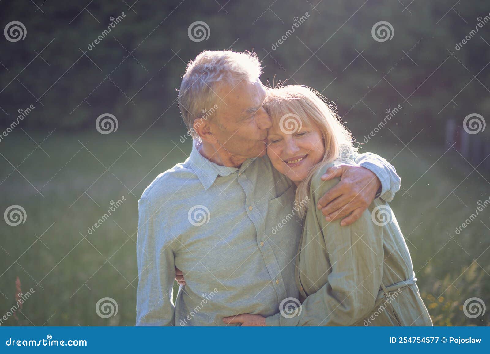 Portrait Of Affectionate Senior Couple Kissing In Nature Stock Image