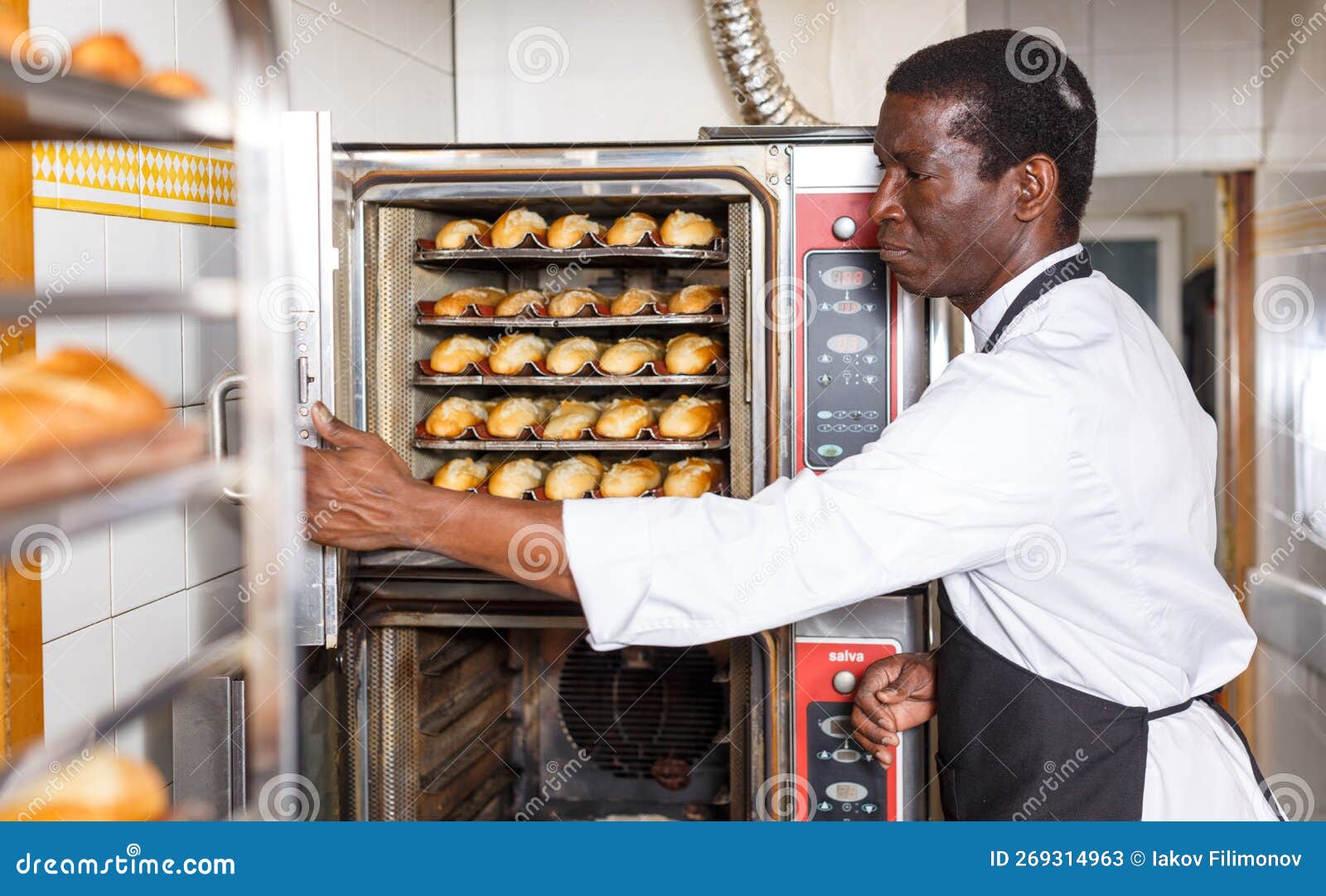 Baker Controlling Process of Baking Bread in Oven Stock Image - Image ...