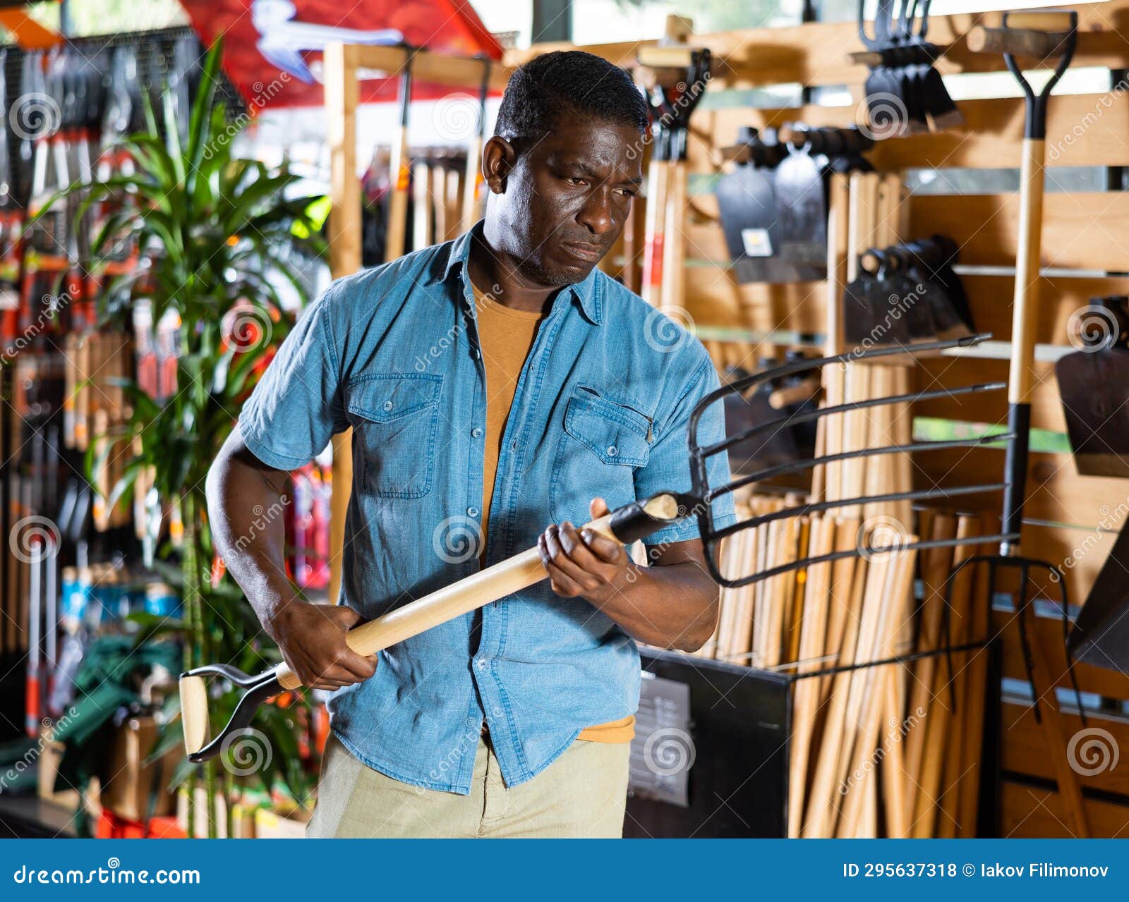 Portrait of an African American Man Choosing Working Tools Stock Photo ...