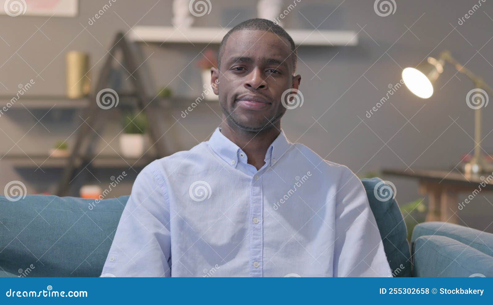 Portrait of African Man Crying Towards the Camera, Sofa Stock Photo ...