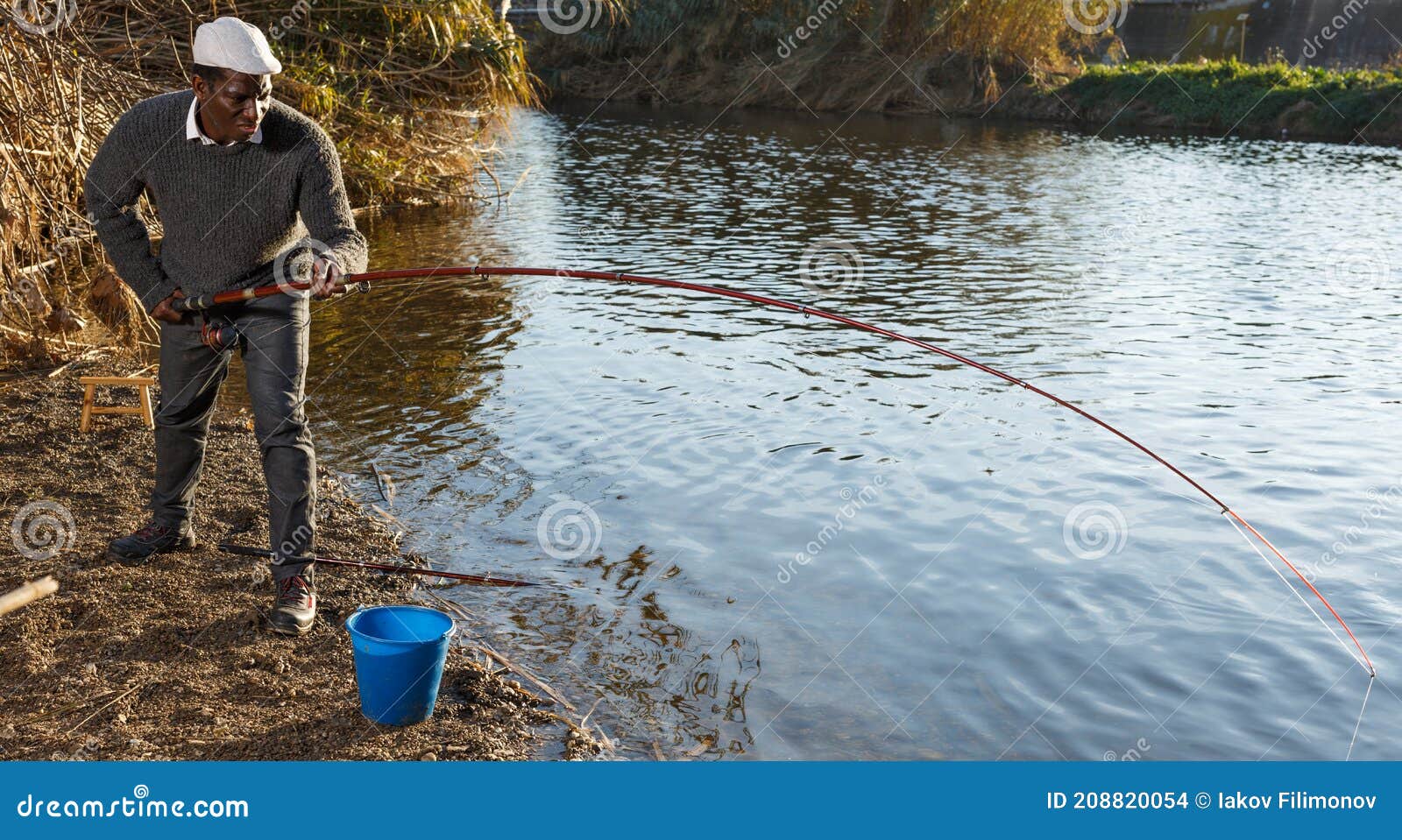 Afro Fisherman Pulling Fish Stock Photo - Image of natural, outdoors ...