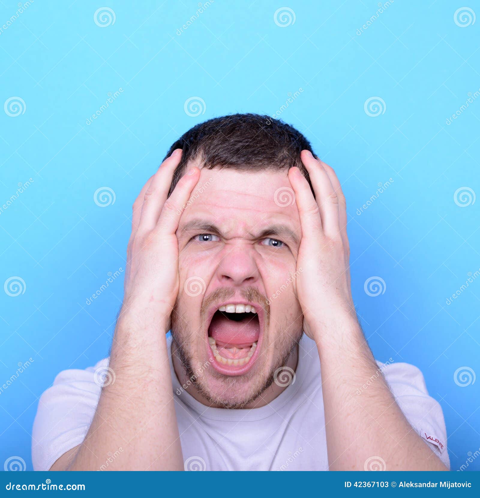 Portrait of Angry Man Screaming and Pulling Hair Against Blue Ba Stock ...