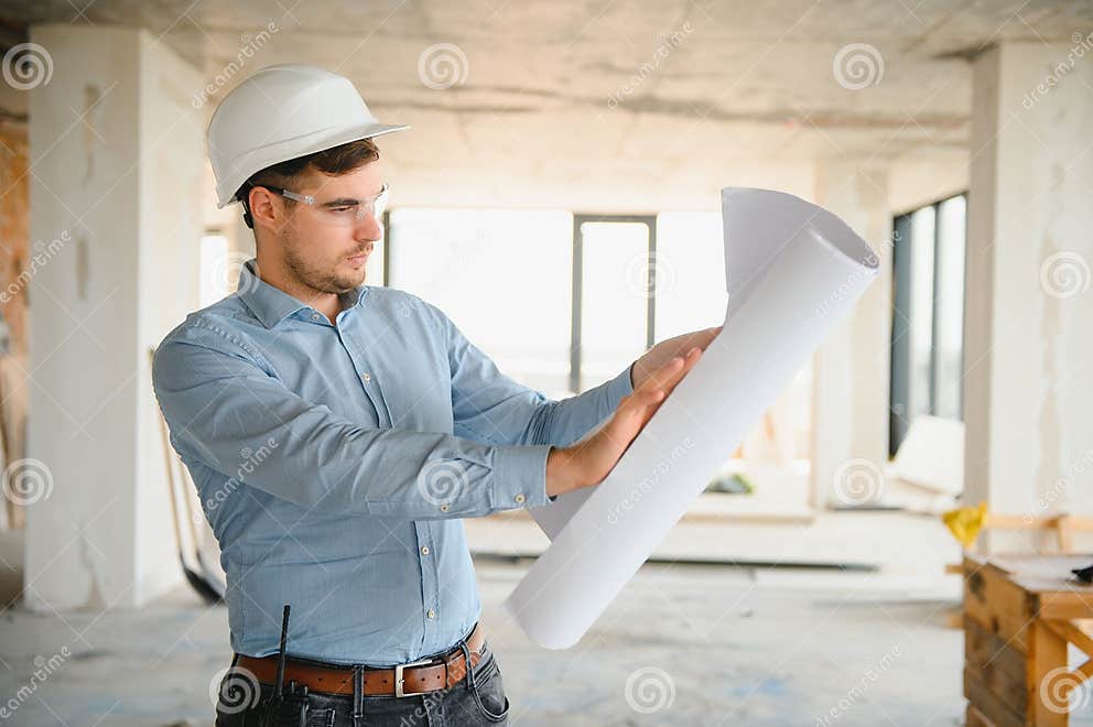 Portrait of an Architect Builder Studying Layout Plan of the Rooms ...