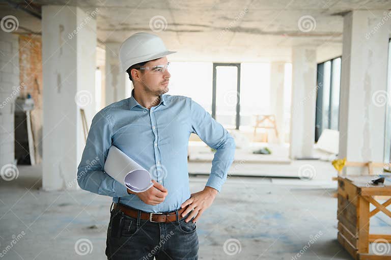 Portrait of an Architect Builder Studying Layout Plan of the Rooms ...