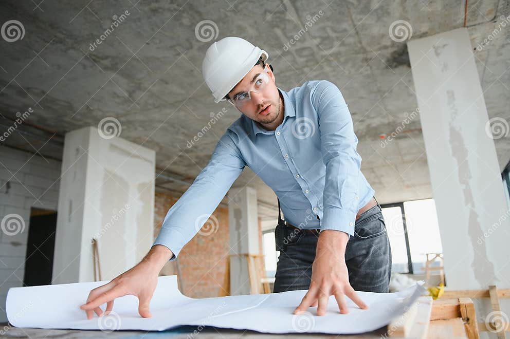 Portrait of an Architect Builder Studying Layout Plan of the Rooms ...