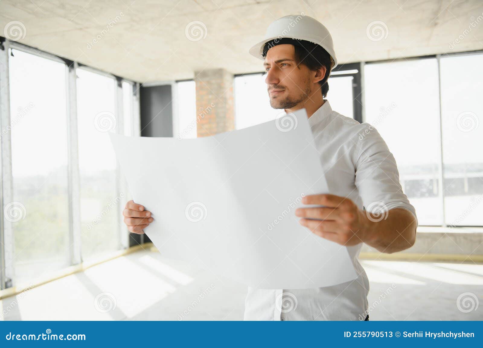 Portrait of an Architect Builder Studying Layout Plan of the Rooms ...