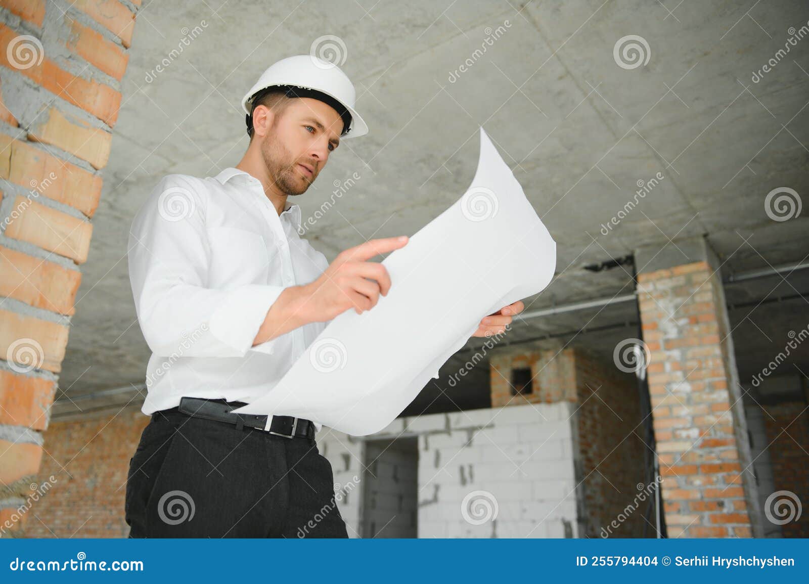 Portrait of an Architect Builder Studying Layout Plan of the Rooms ...