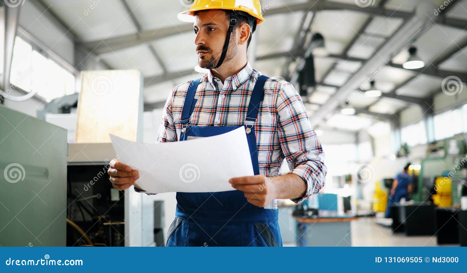 Portrait of an Architect Builder Studying Layout Plans of Plant Stock ... Portrait of an Architect Builder Studying Layout Plans of Plant Stock ...