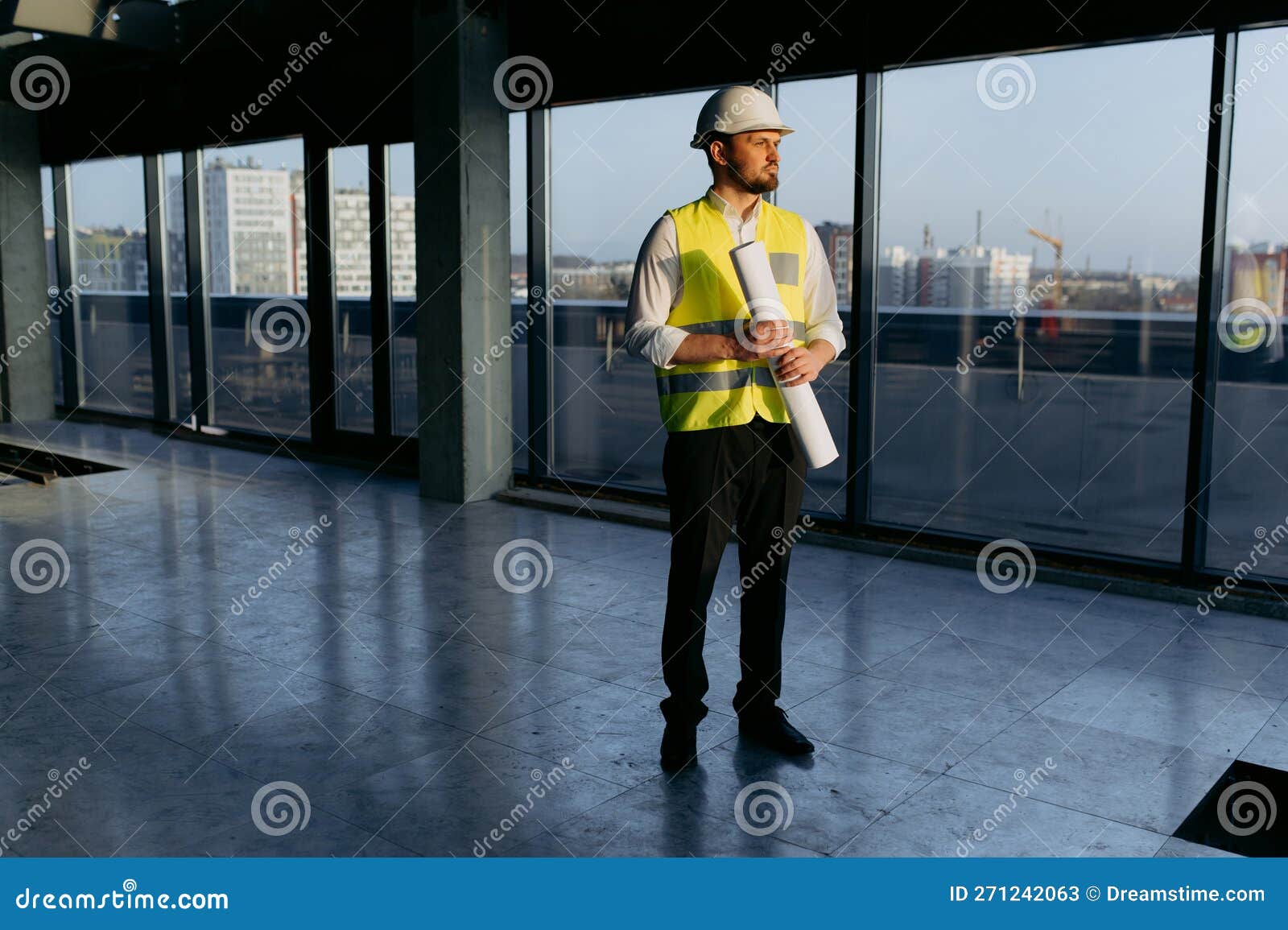 Portrait of an Architect with Construction Drawings. Young Contractor ...