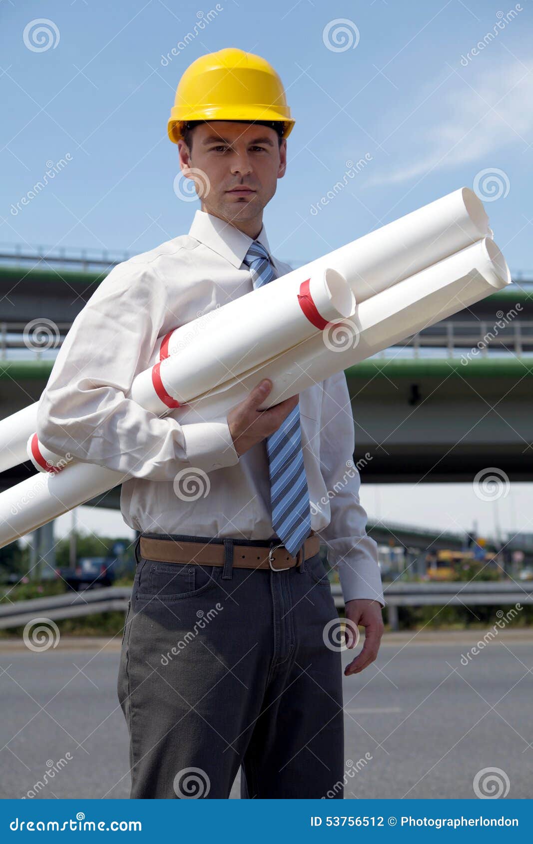 Portrait of Architect in Hardhat Holding Blueprint at Construction Site ... Portrait of Architect in Hardhat Holding Blueprint at Construction Site ...