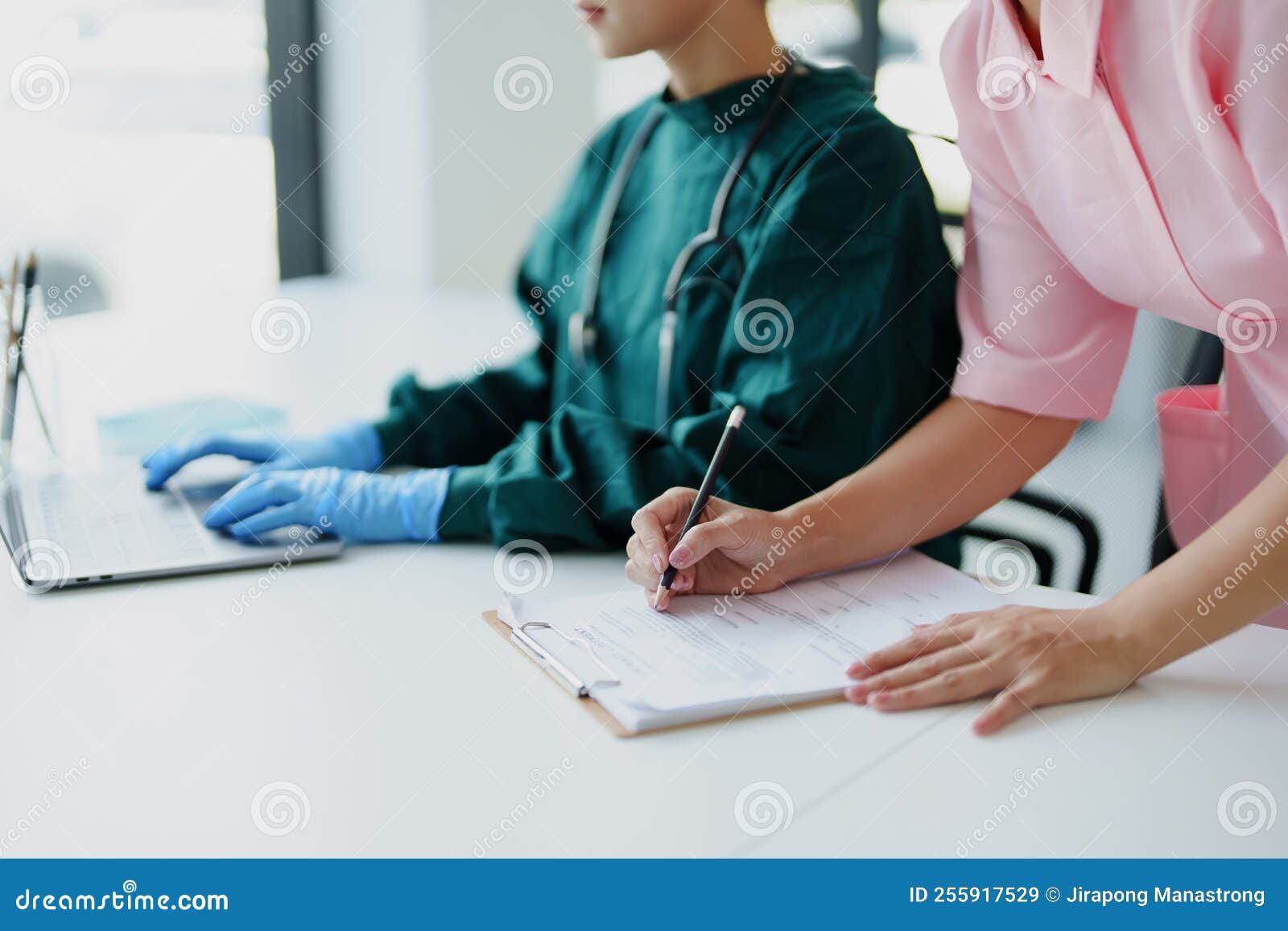 Asian Doctors and Nurses Using Computers and Documents To View Patient ...