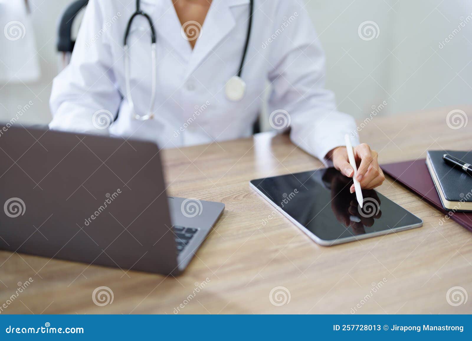 Portrait of an Asian Female Doctor Using a Computer and Tablet To Work ...