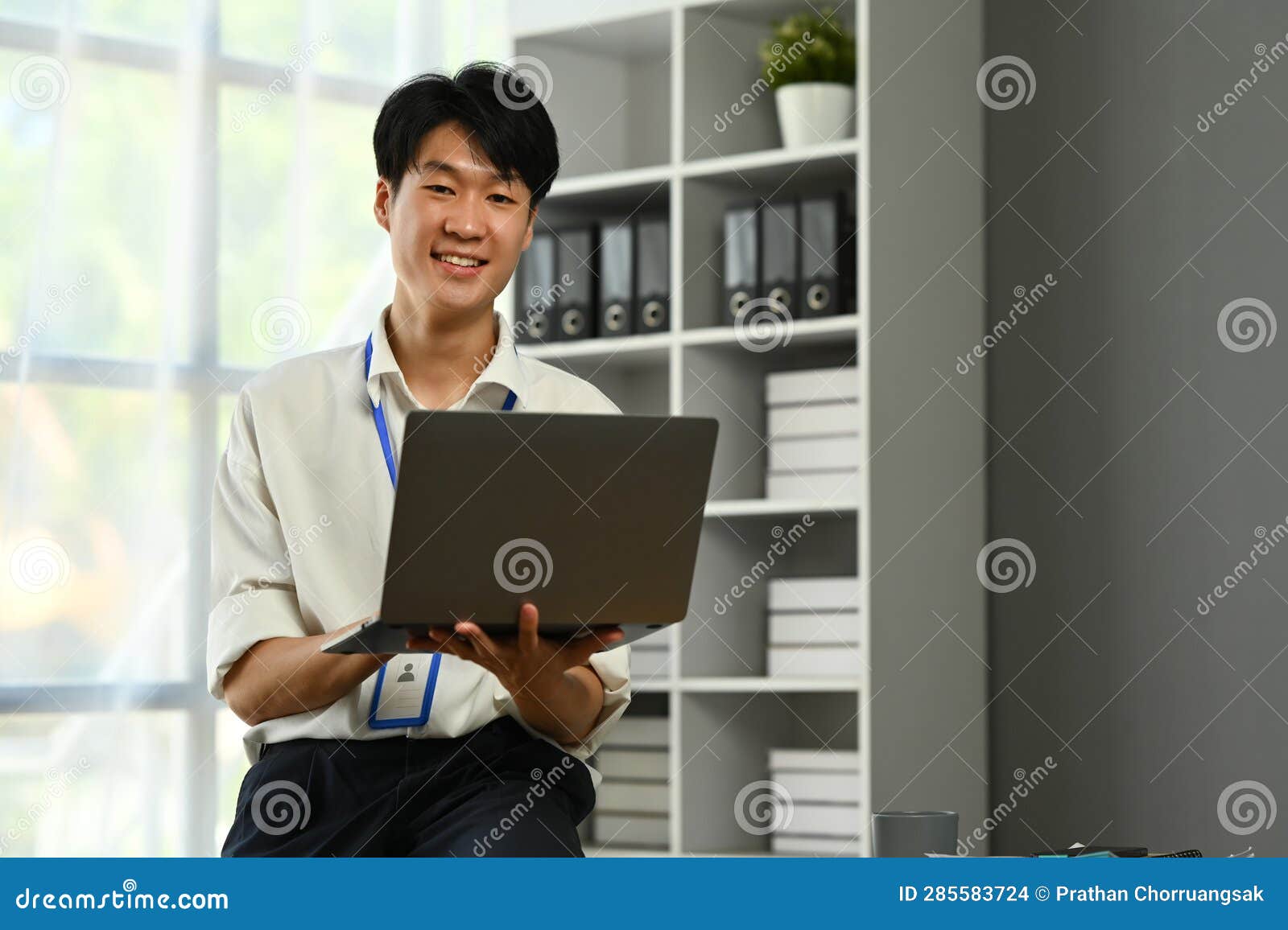 Portrait of Asian Male Manager Sitting on Desk in Modern Workplace and ...
