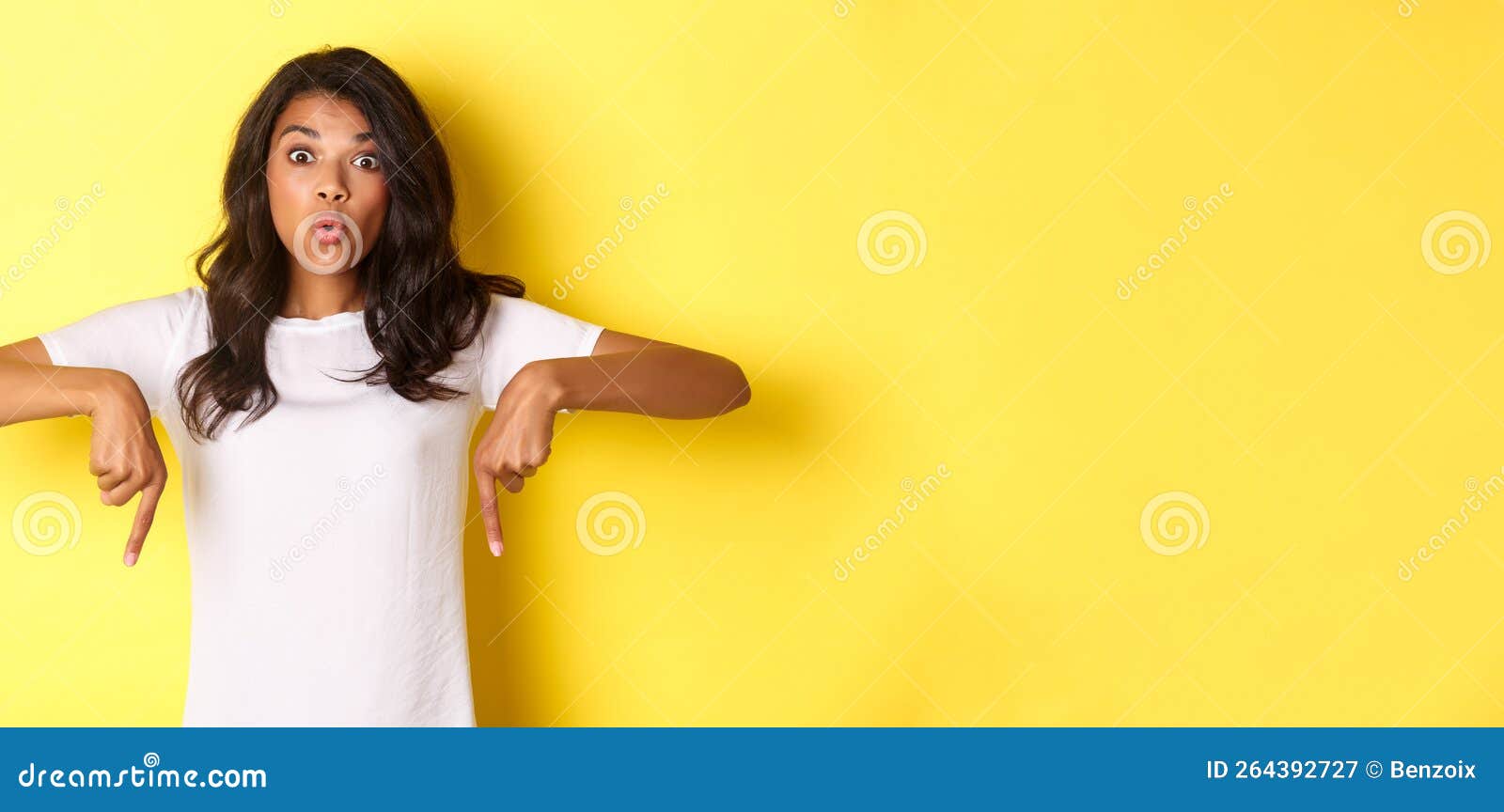 Portrait Of Attractive African American Girl Pointing Fingers Down And