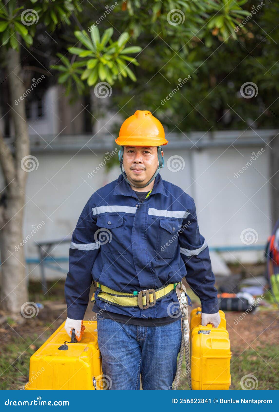 Portrait of an Attractive Electrician in Uniform on a Construction Site ...