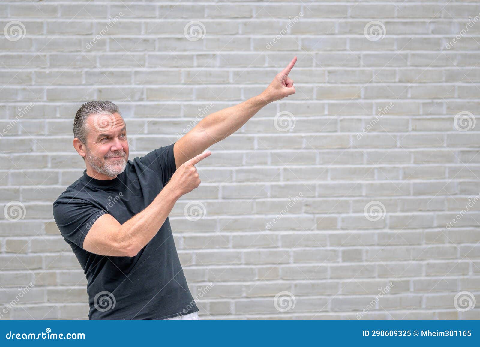 Portrait of an Attractive Friendly Man Pointing To the Right Side and ...