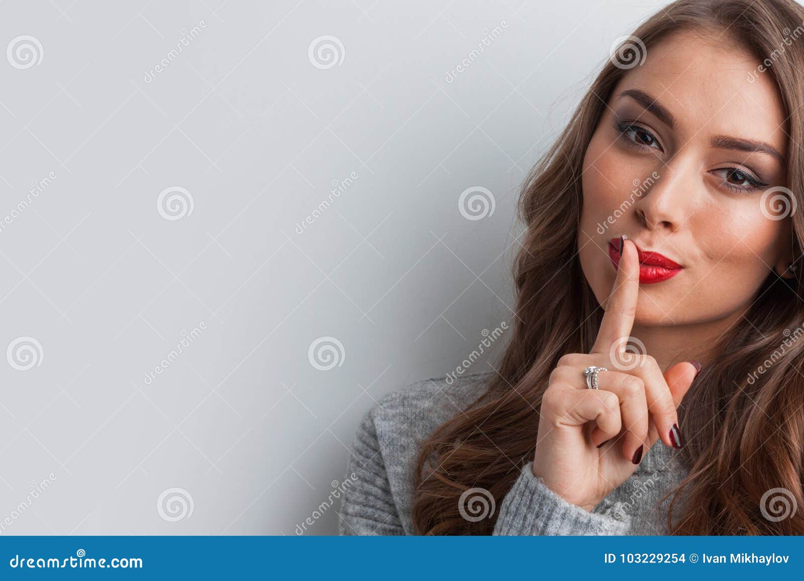 Girl with finger on lips stock photo. Image of adult - 103229254