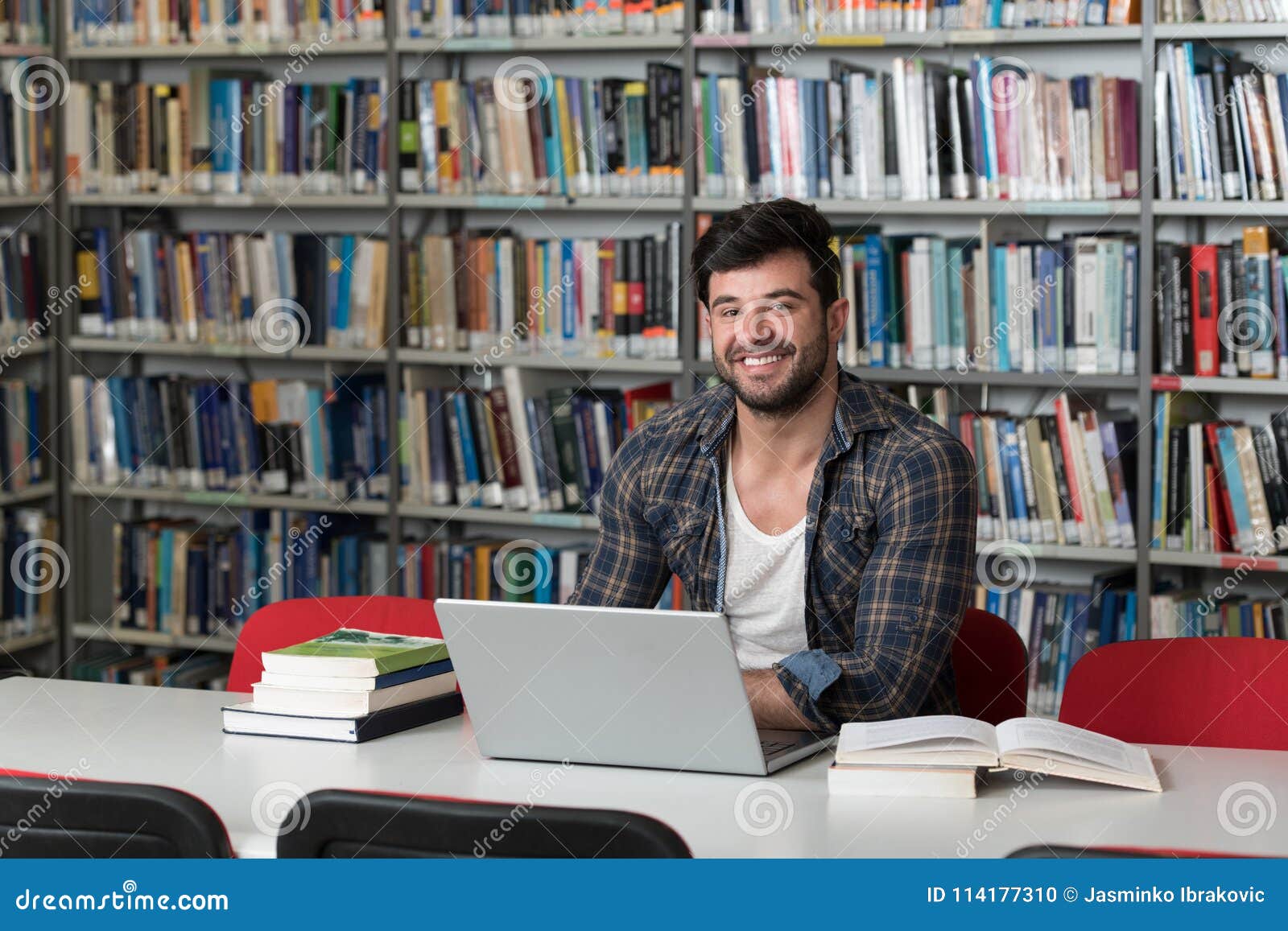 Student Using His Laptop in a Library Stock Photo - Image of person ...